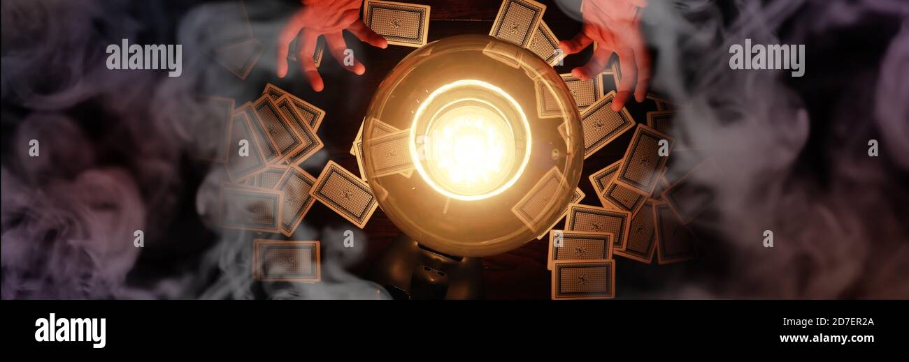 A sorcerer's table with a fortune-teller ball and mask Stock Photo - Alamy