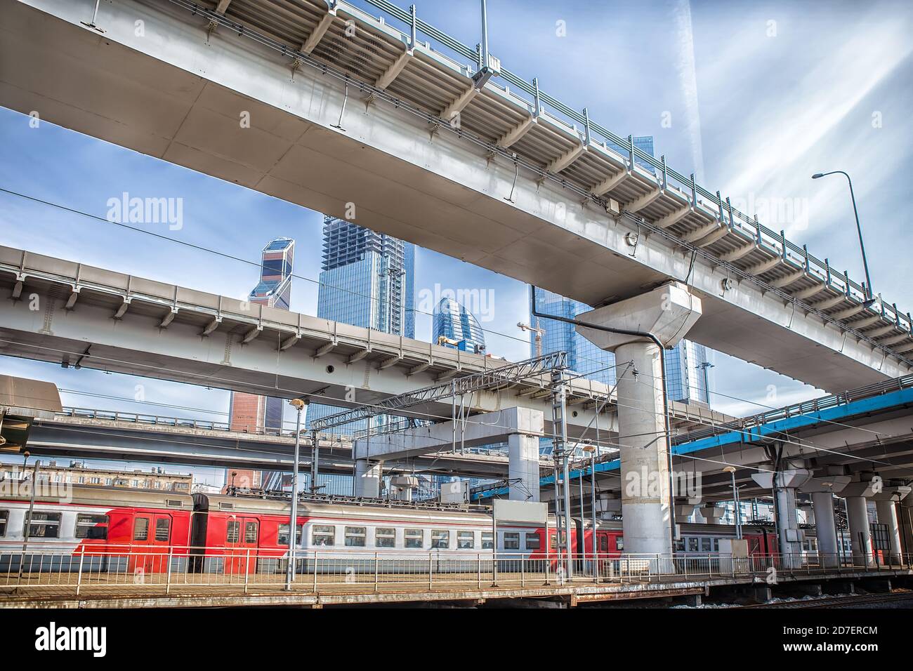 urban landscape with railway station , train, road junction and bridges ...