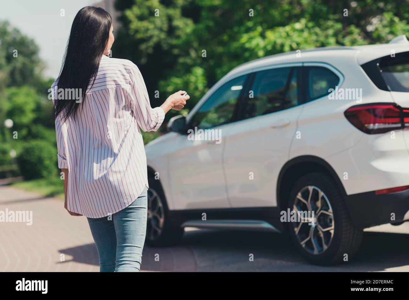 Back rear spine view photo of girl new car owner go walk auto open door ...
