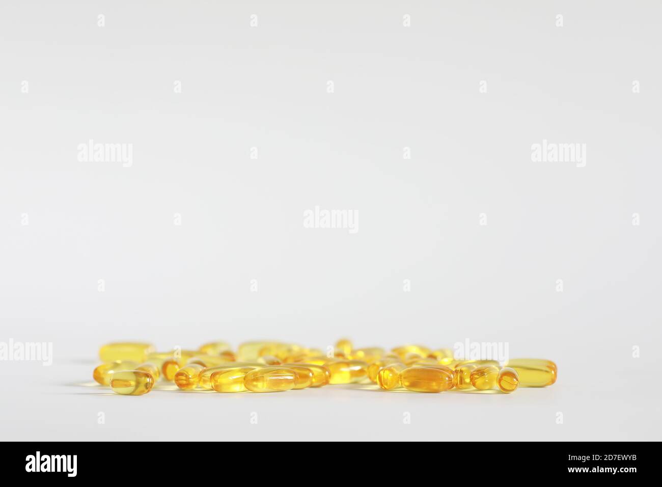 Medical medicines and supplements transparent capsules of yellow color ...