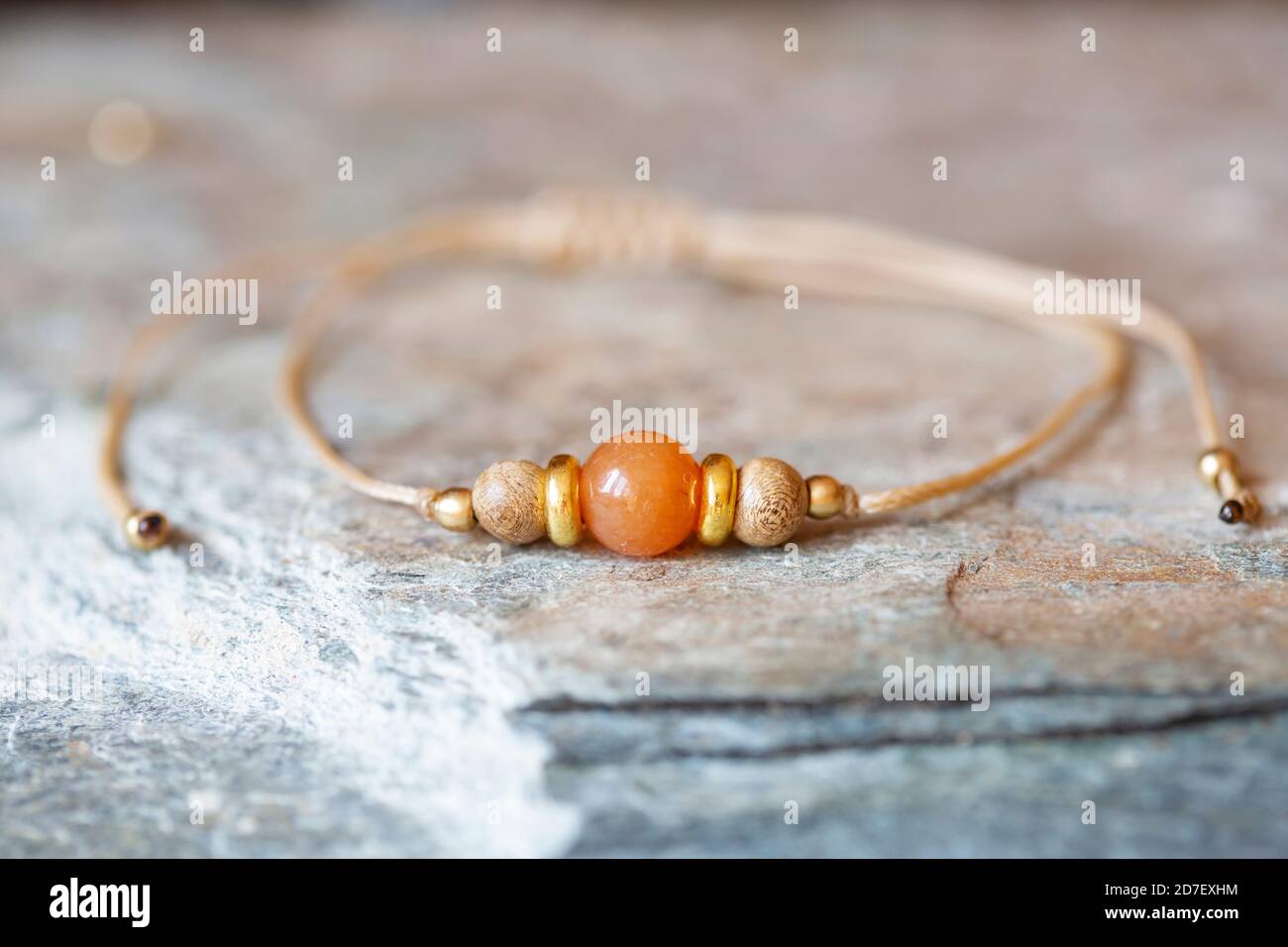 Carneol gemstone natural beads bracelet on grey rocky background Stock ...