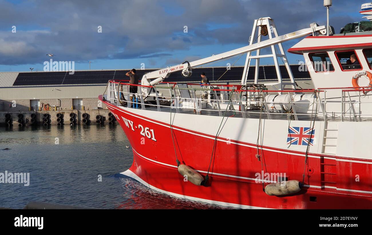 Red fishing boat at Peterhead fish market Stock Photo - Alamy