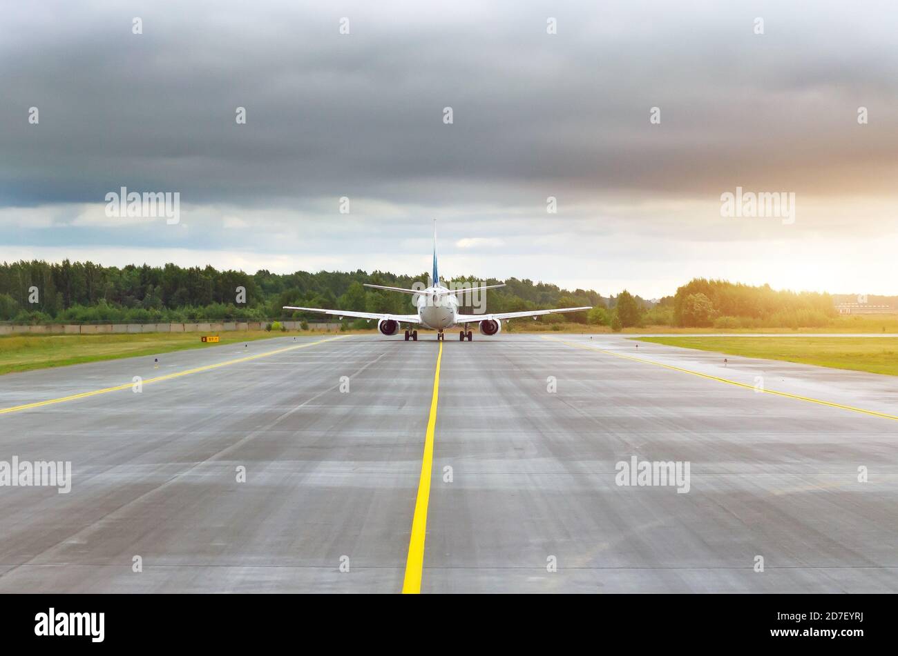 Aircraft taxiing to take off on the runway on the track in the distance ...