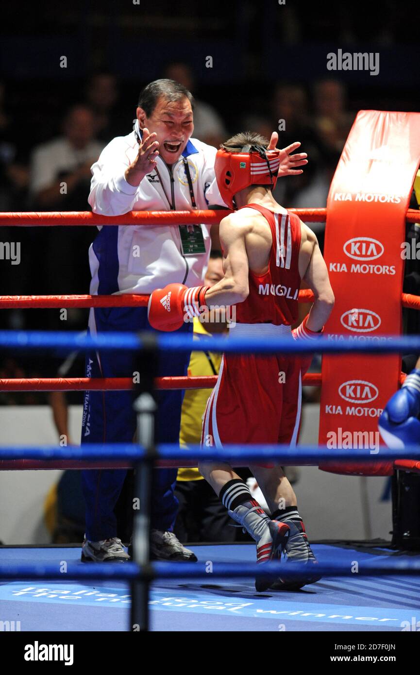 Mongolia's boxer and coach at the ring's corner, during an amateur ...
