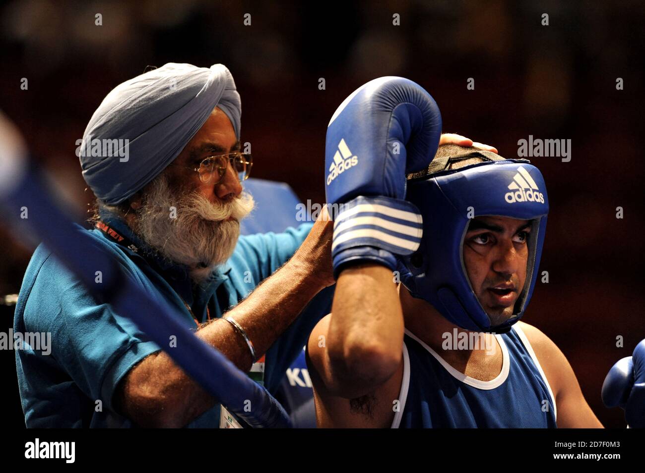 Indian boxer and coach at the ring's corner during an amateur boxing ...