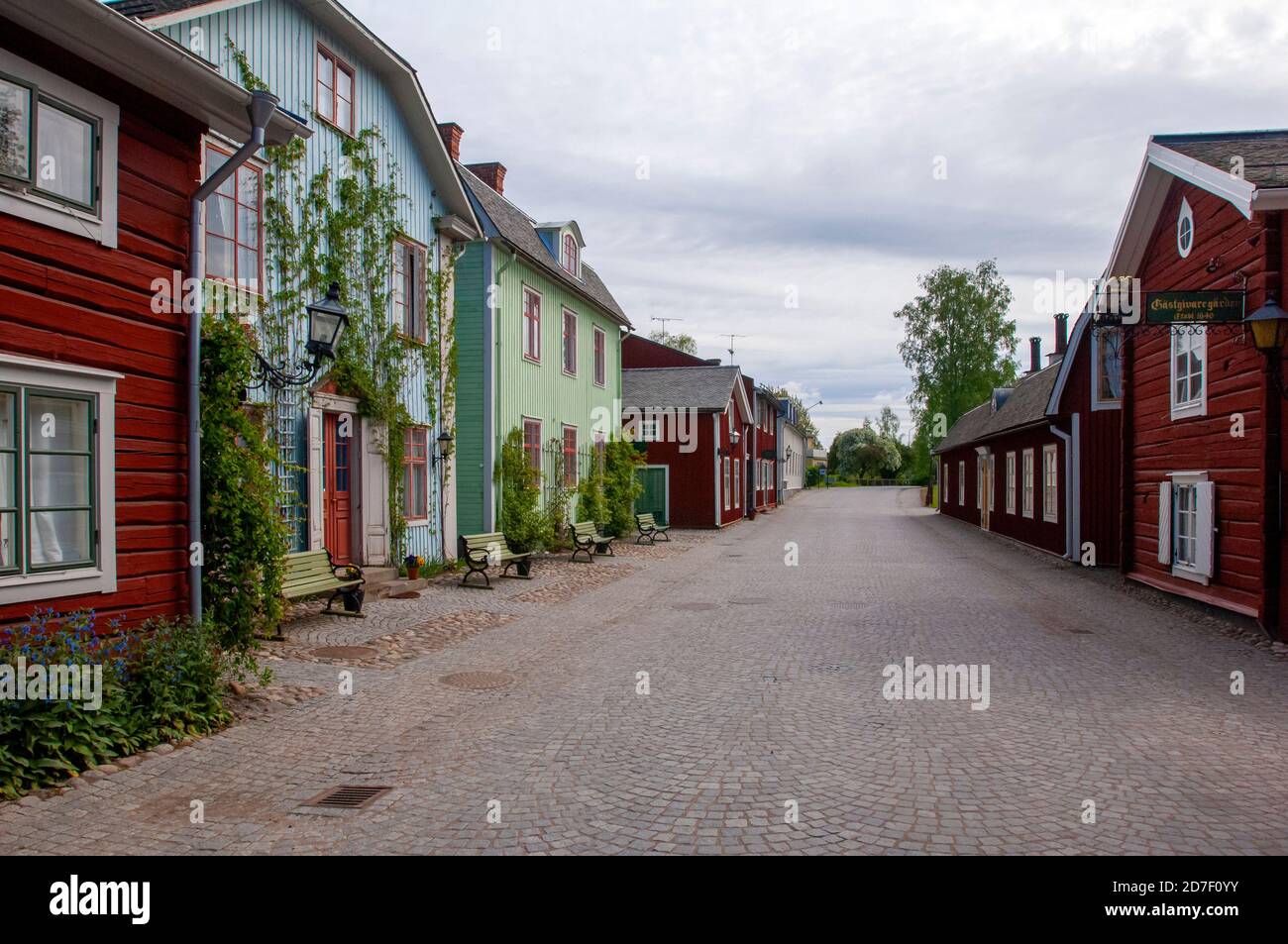 A paving stone street with traditional beautiful old houses and a ...