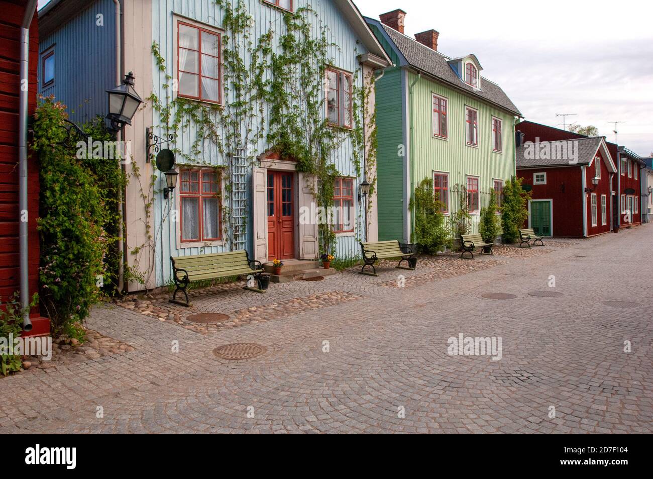A paving stone street with traditional beautiful old houses and a ...