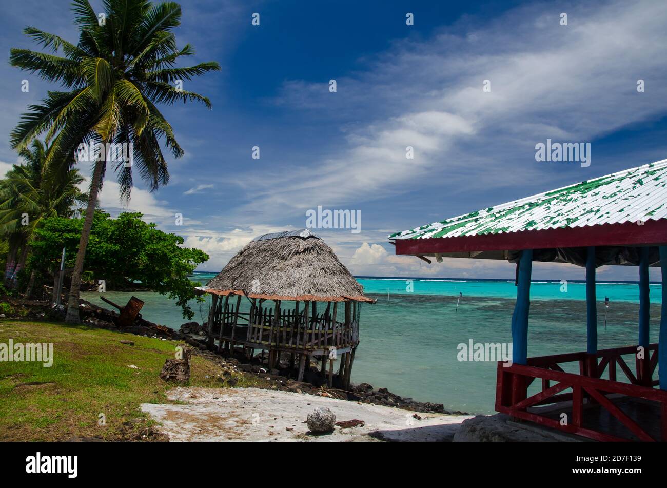 Beach fales surrounded by greenery and sea under the sunlight in Savai ...