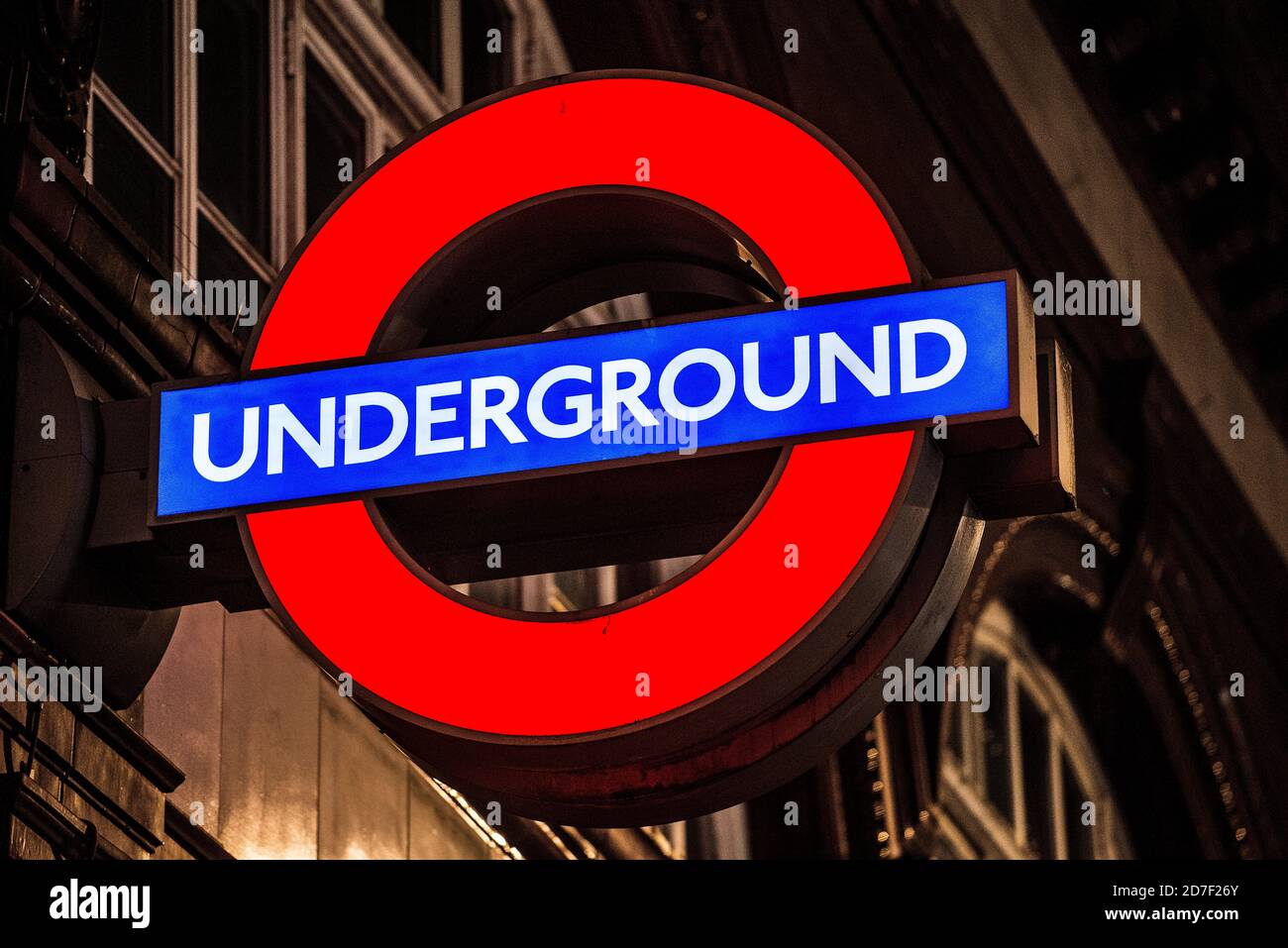 Illuminated London Underground tube station sign at night Stock Photo ...