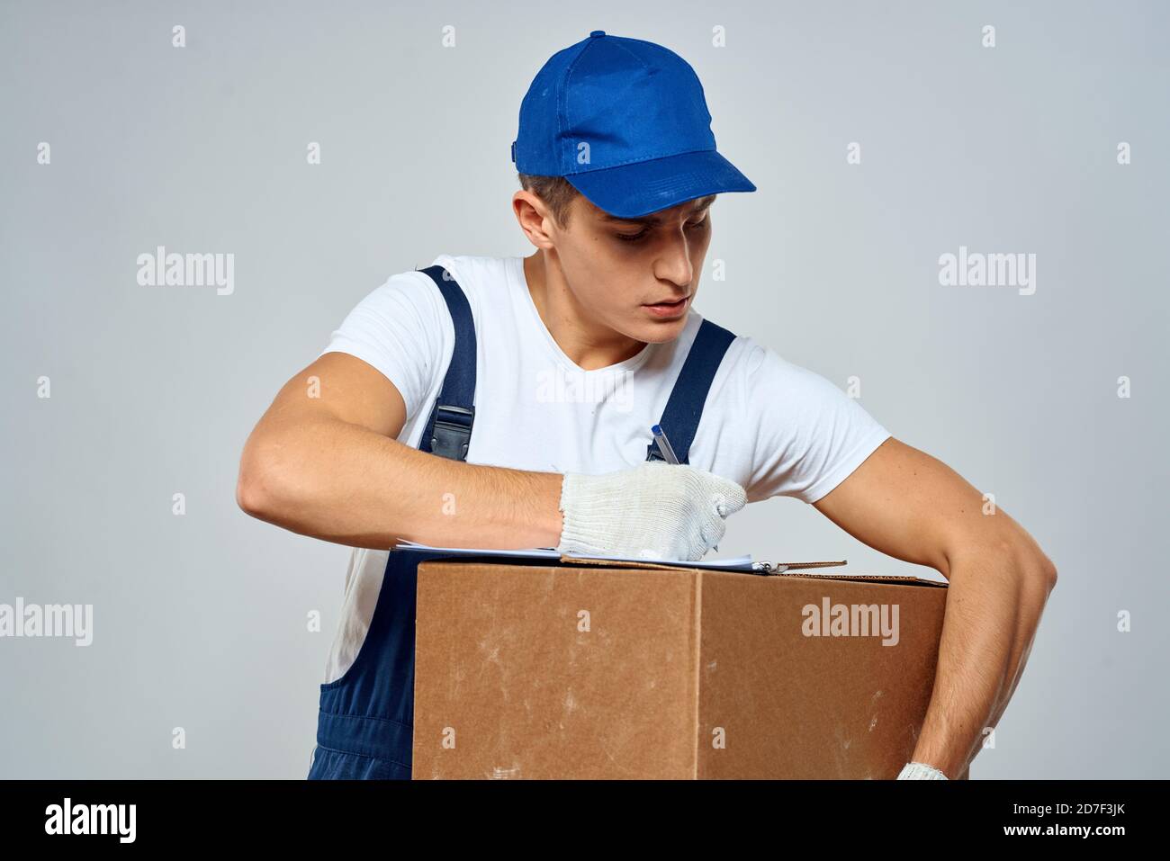 Man worker with box in hands delivery loading service packing service ...