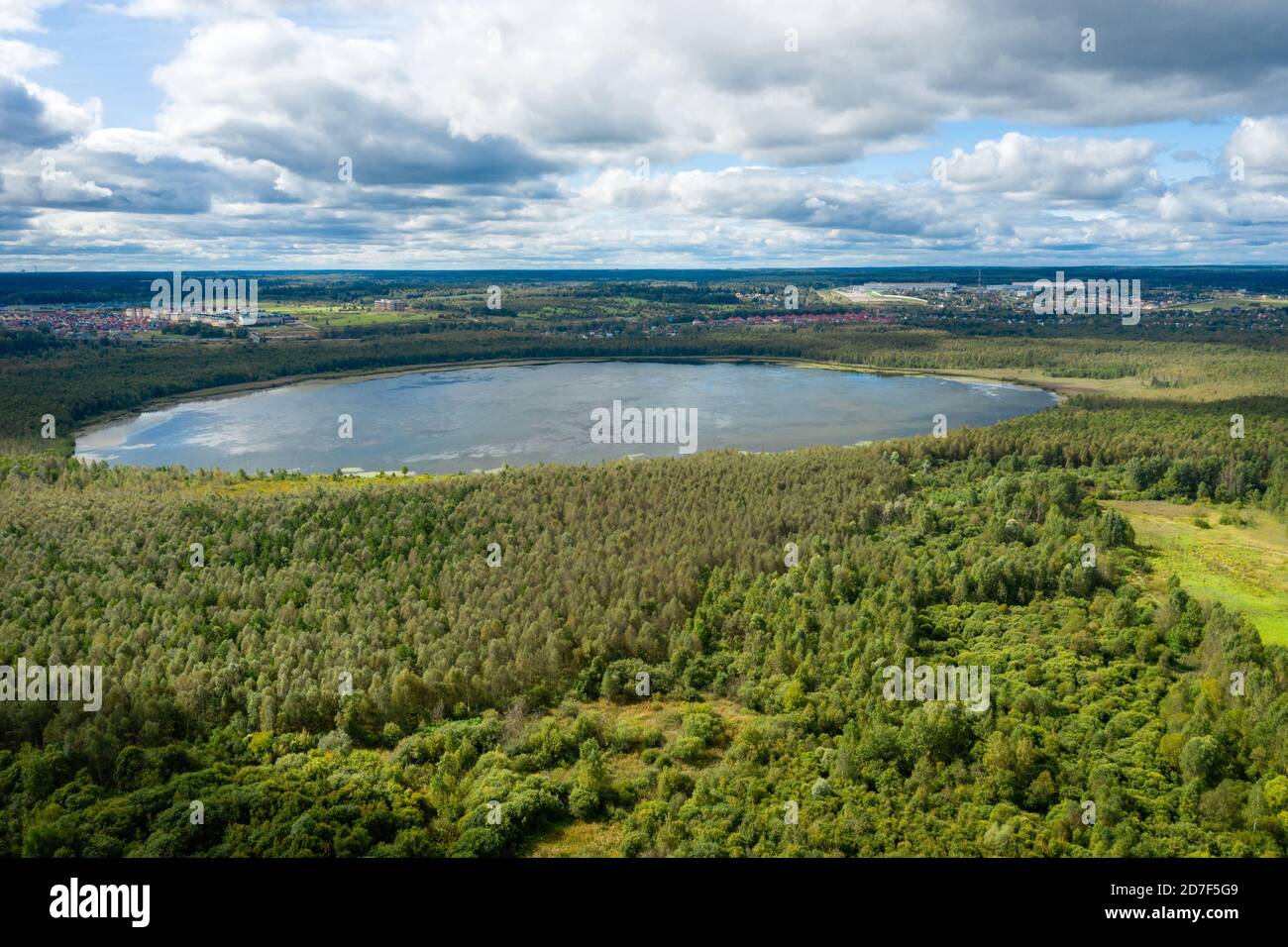 Aerial view of the countryside and a circular lake in the middle of the ...
