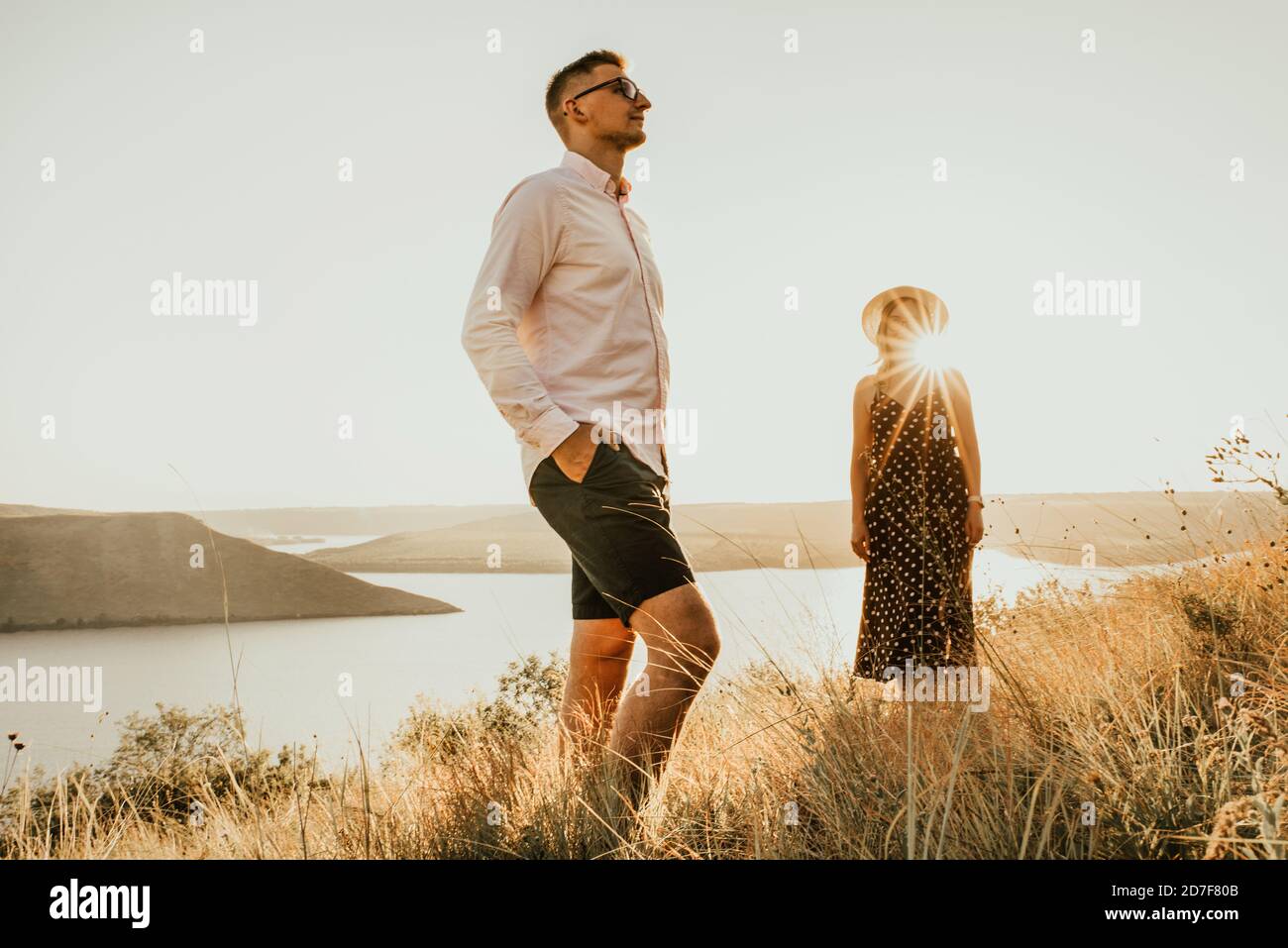 woman behind man in rays of setting sun in summer Stock Photo - Alamy