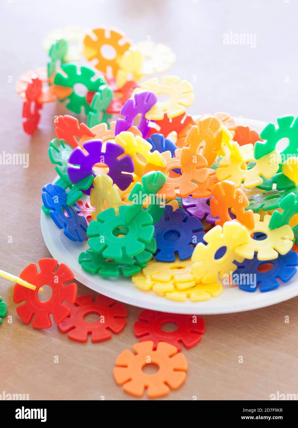 Plastic flakes blocks on plate. Instructive toy that promotes spatial ...