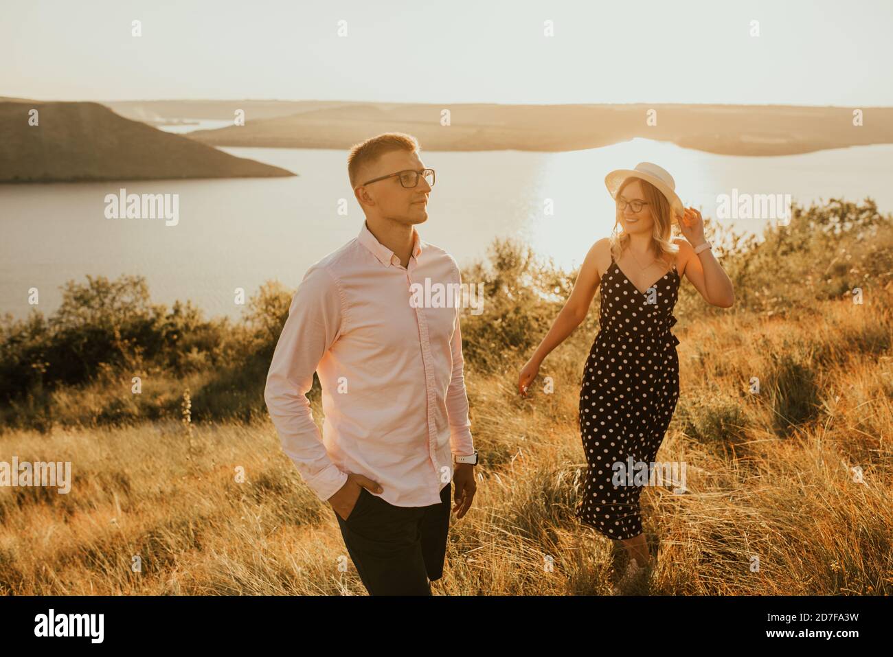 woman behind man in rays of setting sun in summer Stock Photo - Alamy