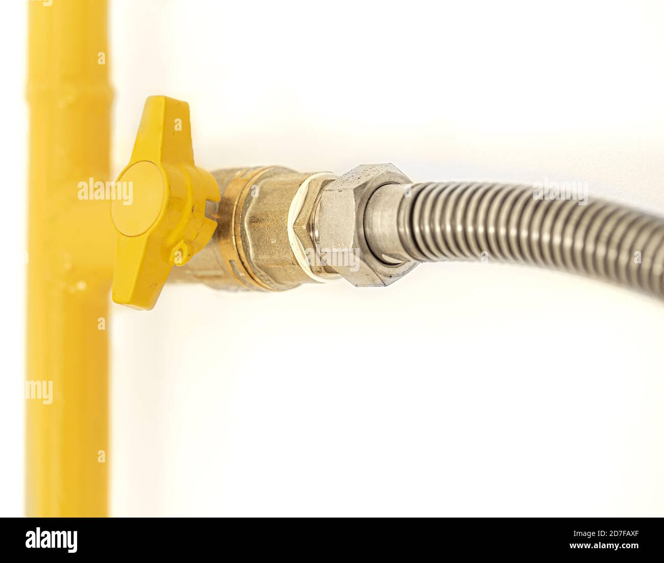 Yellow gas pipe with a valve. White background. Space for text Stock ...