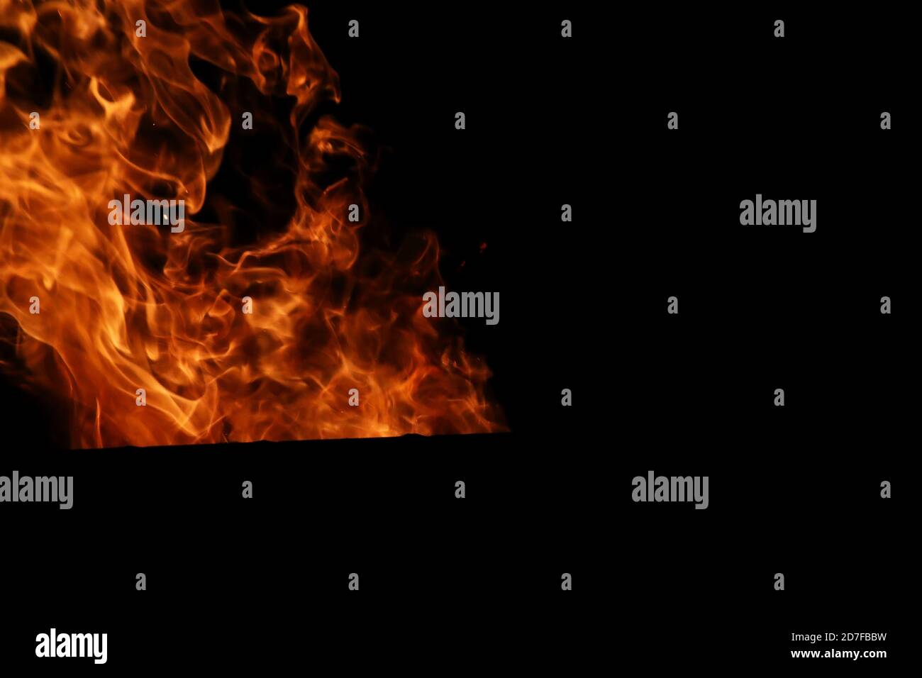 Tongues of a flame of fire of orange-yellow color from burning firewood ...