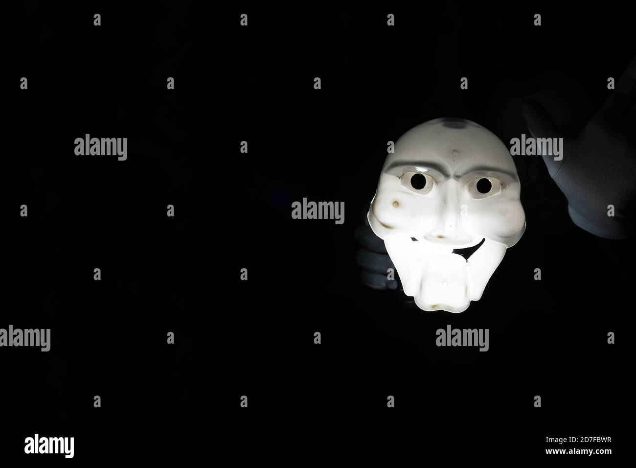 White scary mask on a black background with whites hands Stock Photo ...