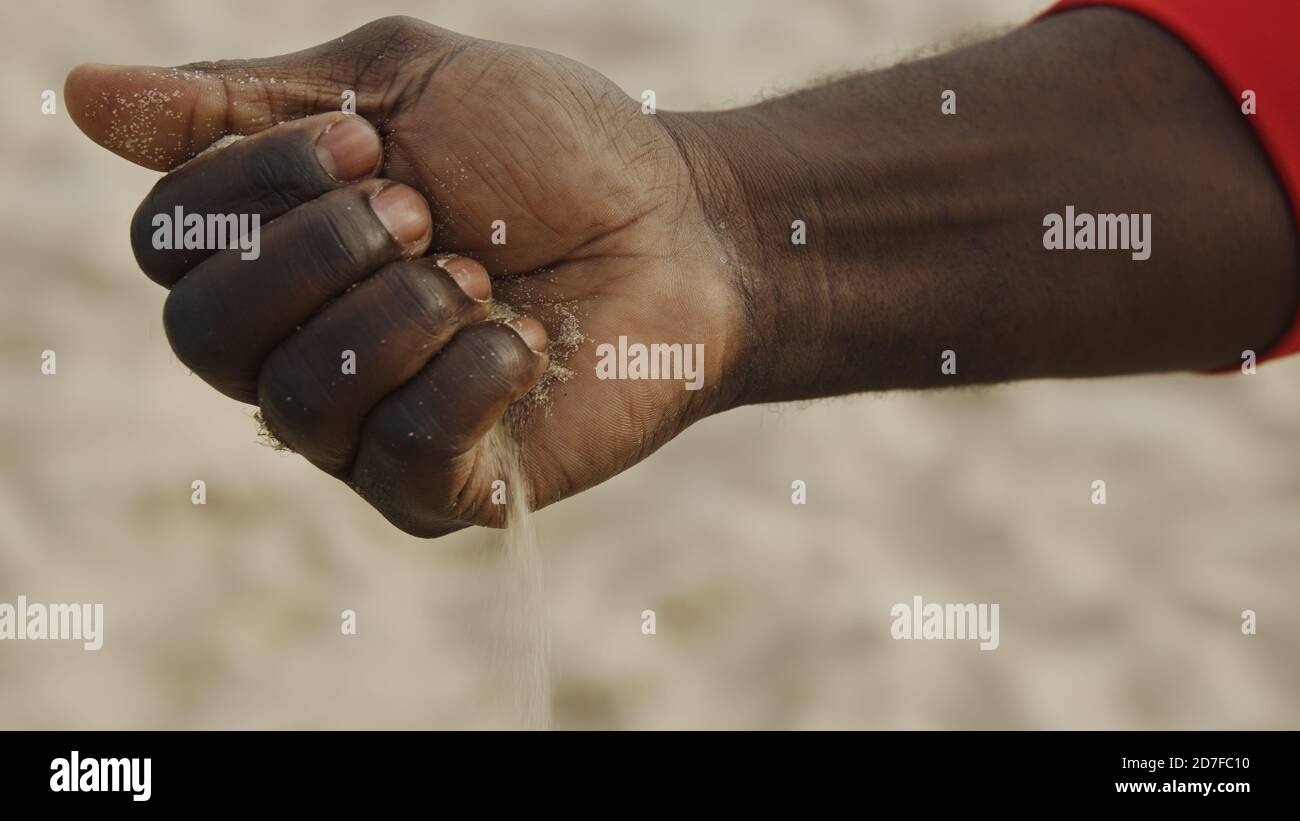 Man hands holding spilling sand hi-res stock photography and images - Alamy