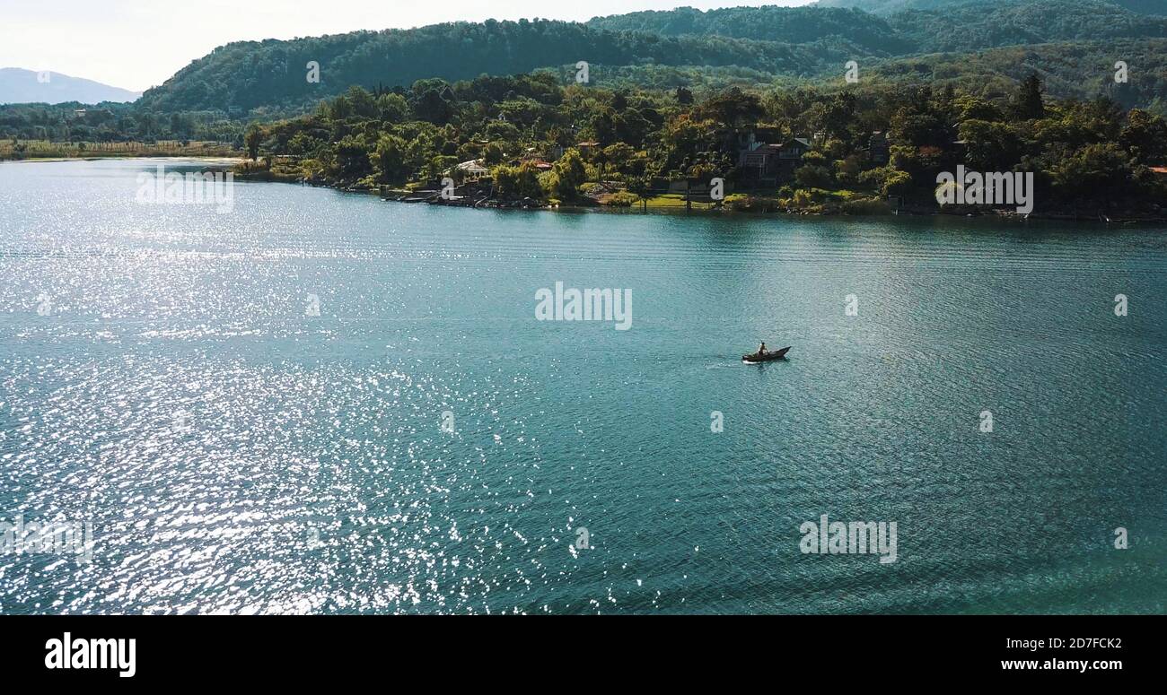 Aerial view of a small boat sailing at the Lake Atitlan in Guatemala ...