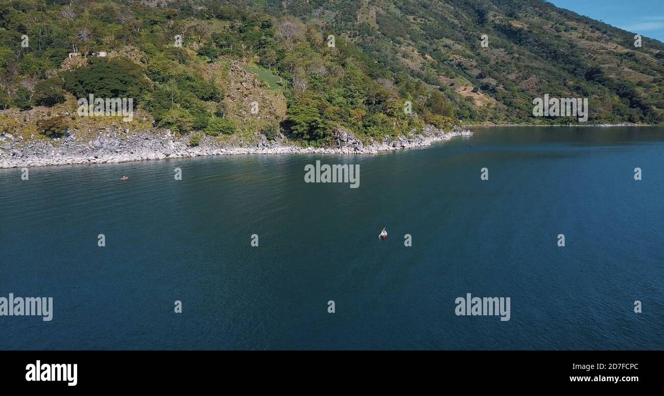 Aerial view of a small boat sailing at the Lake Atitlan in Guatemala ...