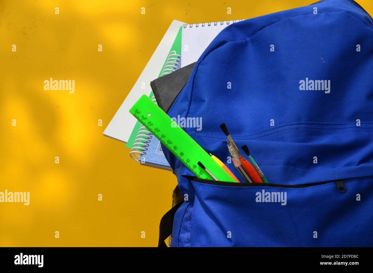 Full School backpack on yellow background. school supplies ruler ...