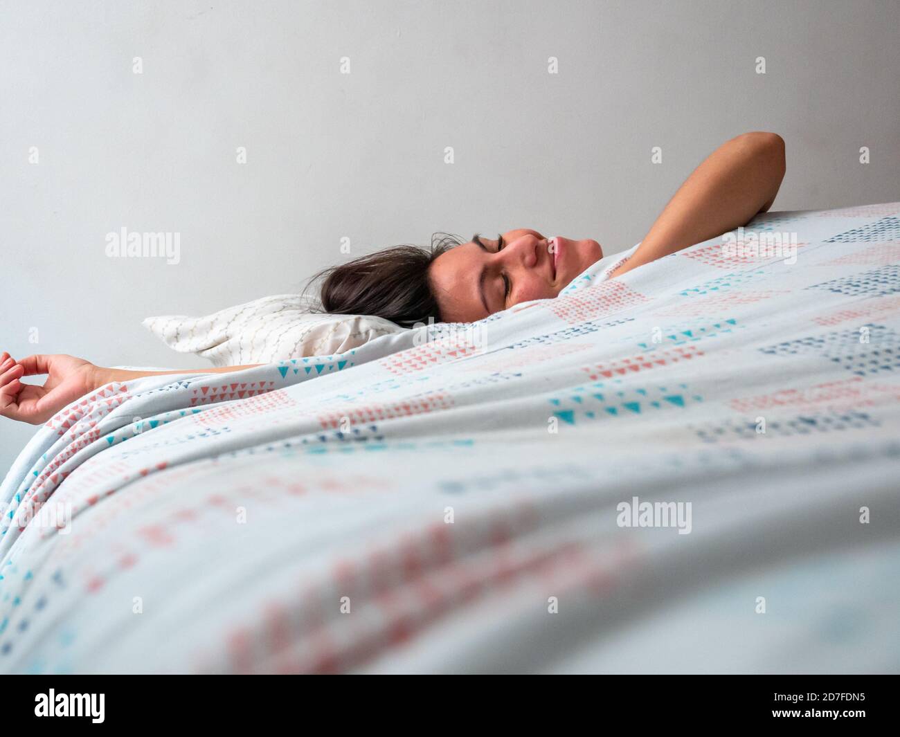 Young Brown Hair Hispanic Female Waking up Happy in her Bed Stock Photo ...