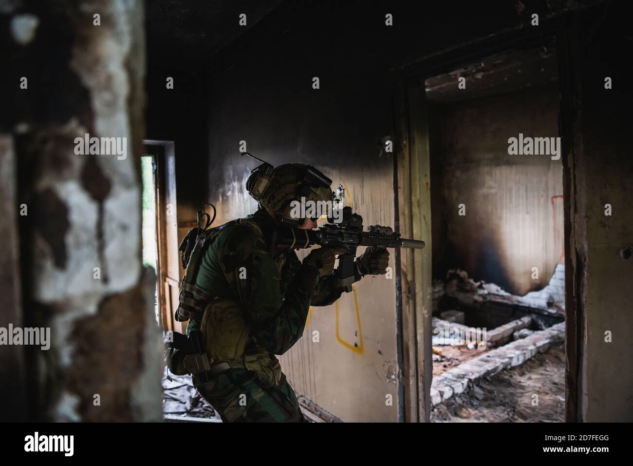 Soldier in combat. Urban combat training, soldier entering abandoned ...