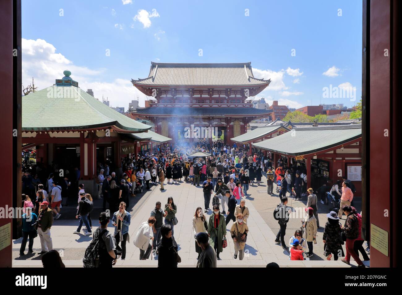 Kaminarimon (Thunder Gate) with visitors burning incense in front of it ...