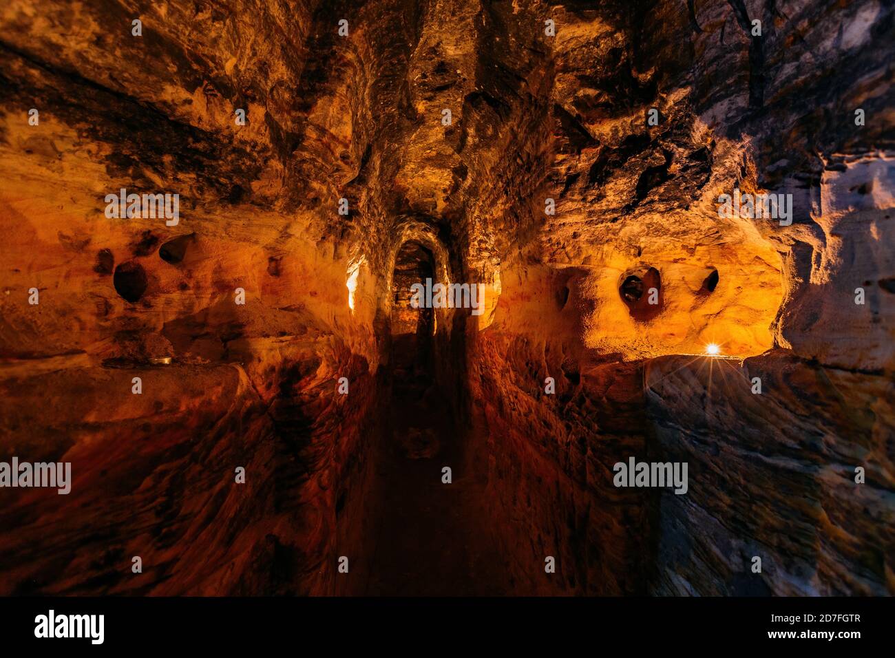 Ancient narrow underground passage in sandstone at old underground ...