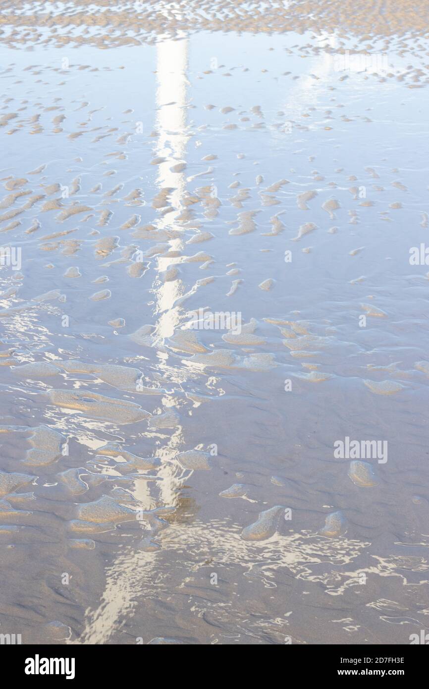 Textures made by water and wind on the sand at the beach, reflections ...
