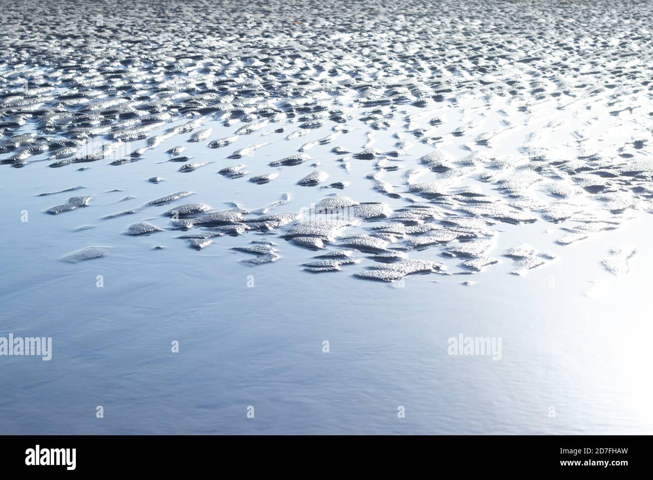 Textures and shapes made by water and wind on the sand, at the beach ...