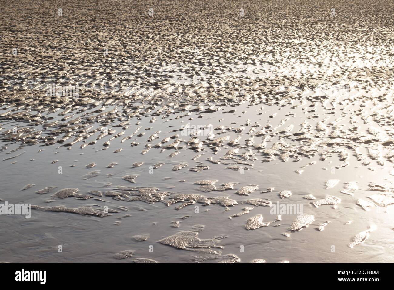 Textures and shapes made by water and wind on the sand, at the beach ...