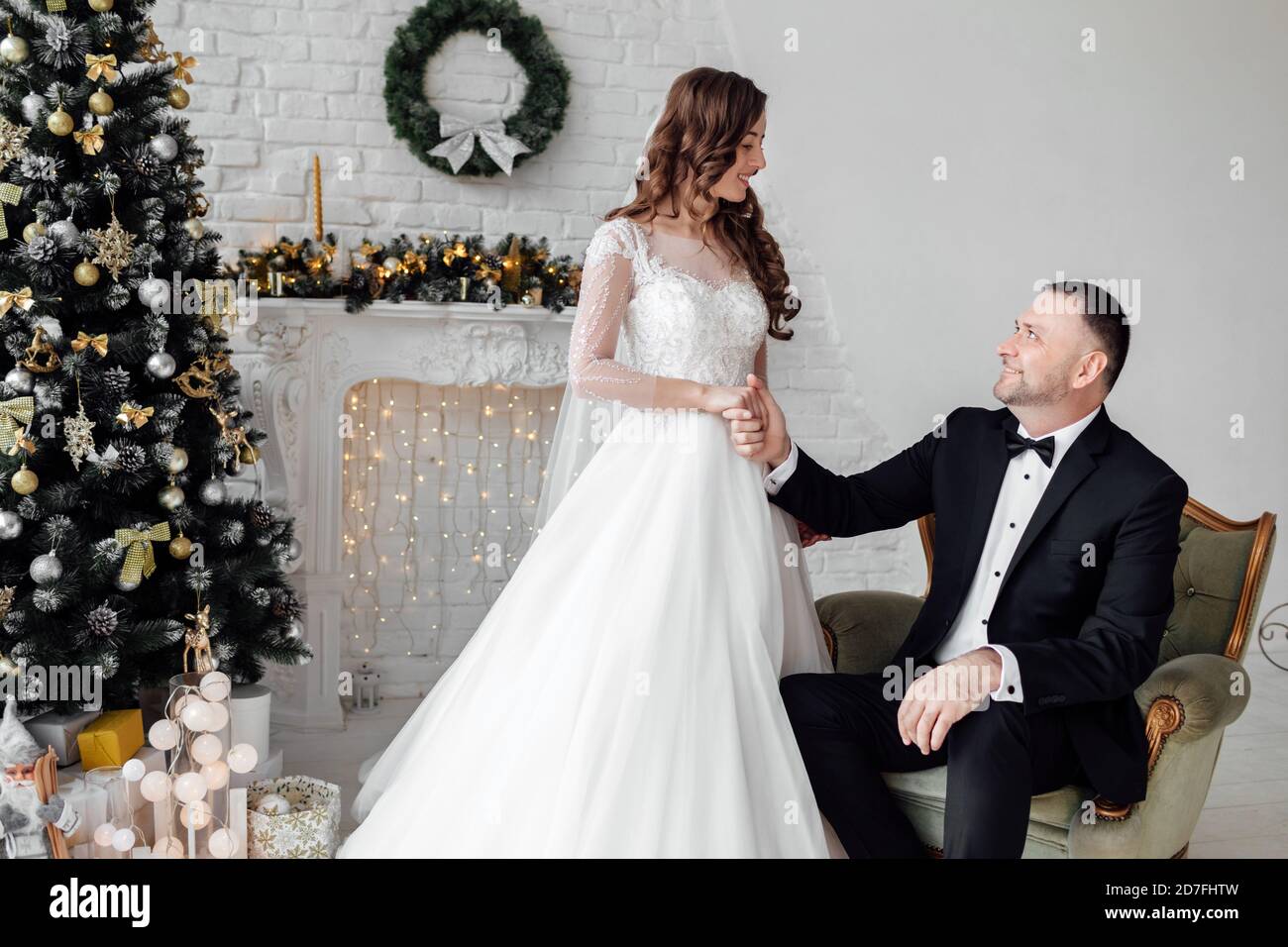 Young couple in love bride and groom posing in studio on background ...