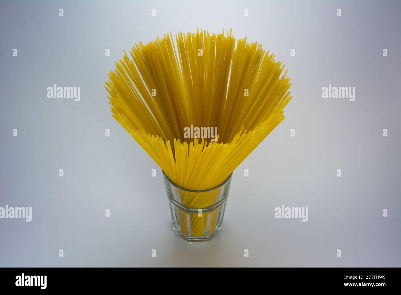 Spaghetti in a cup on a white background Stock Photo - Alamy