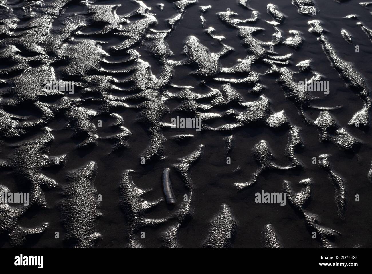 Textures and shapes made by water and wind on the sand, at the beach ...