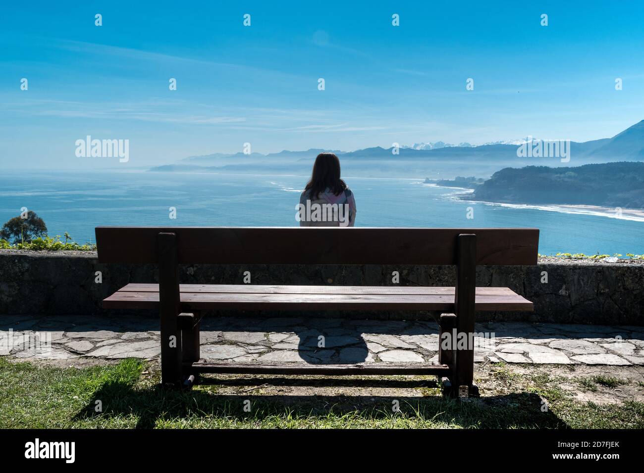 brunette woman on her back leaning out with a bench Stock Photo - Alamy