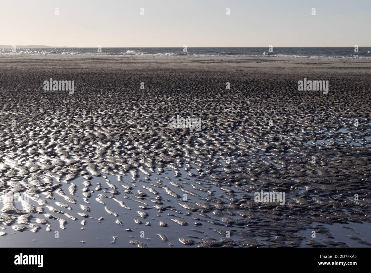 Textures made by water and wind on the sand at the beach, reflections ...