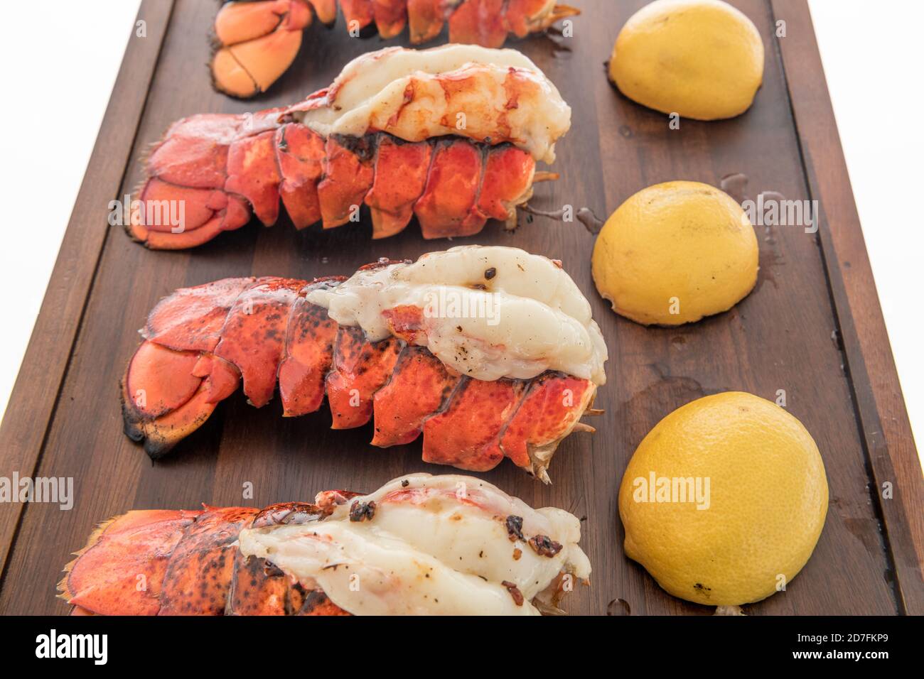 Lobster tails that are saddleback style cooked with lemons Stock Photo ...