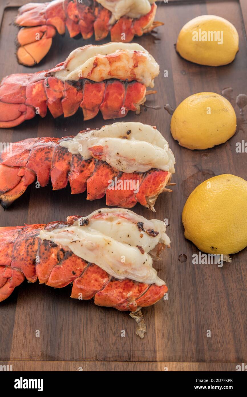 Lobster tails that are saddleback style cooked with lemons Stock Photo ...