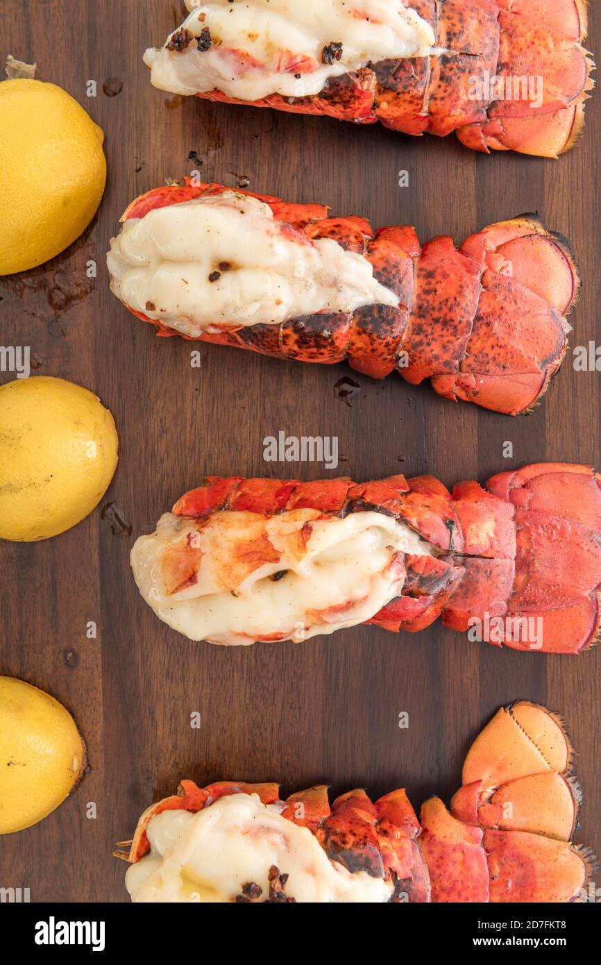 Lobster tails that are saddleback style cooked with lemons Stock Photo ...