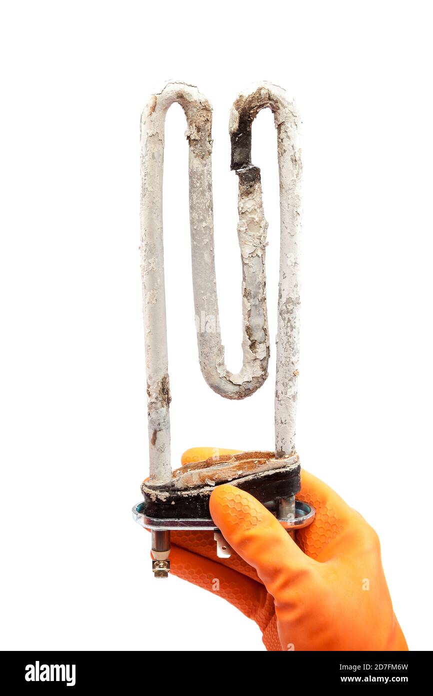 Damaged heating element of the washing machine in hand isolated on ...