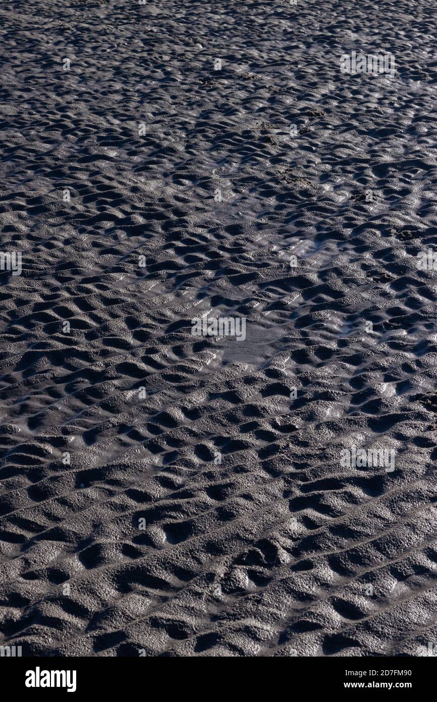 Textures and shapes made by water and wind on the sand, at the beach ...