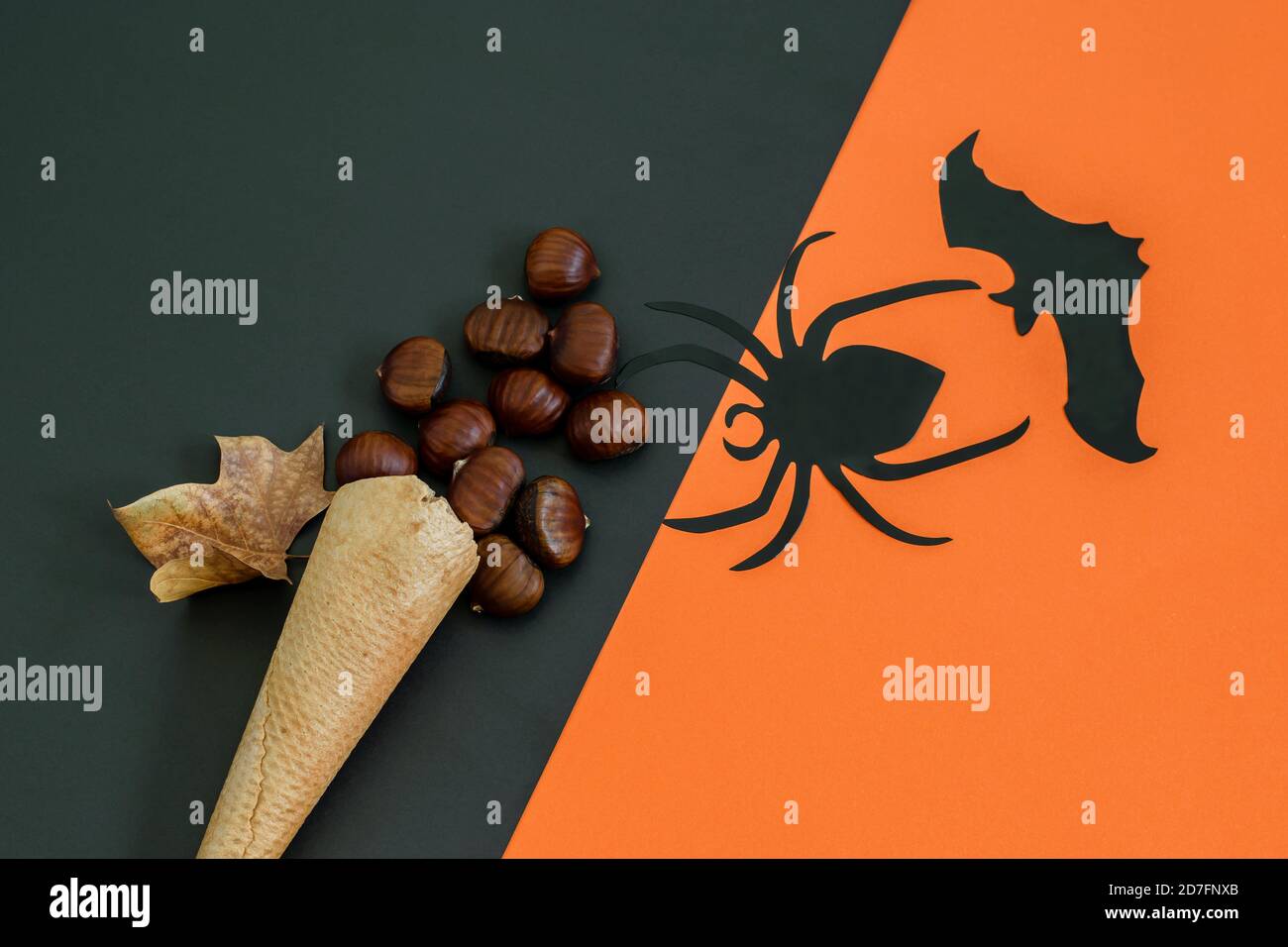 Black spider, bat and waffle ice cream cone with chestnuts on the black ...
