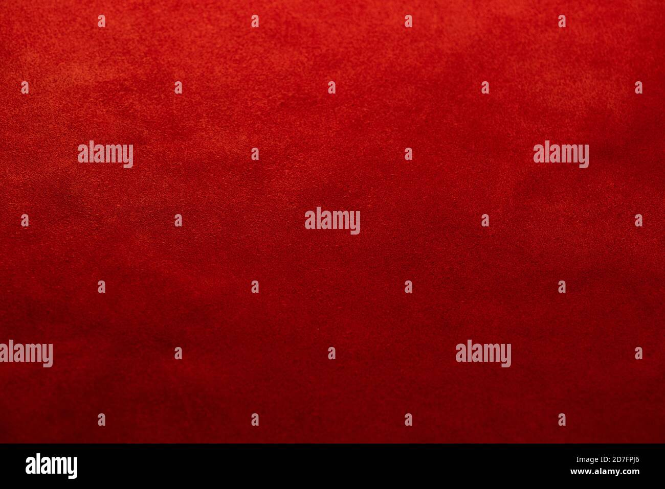 Red matte background of suede fabric, closeup. Velvet texture of ...
