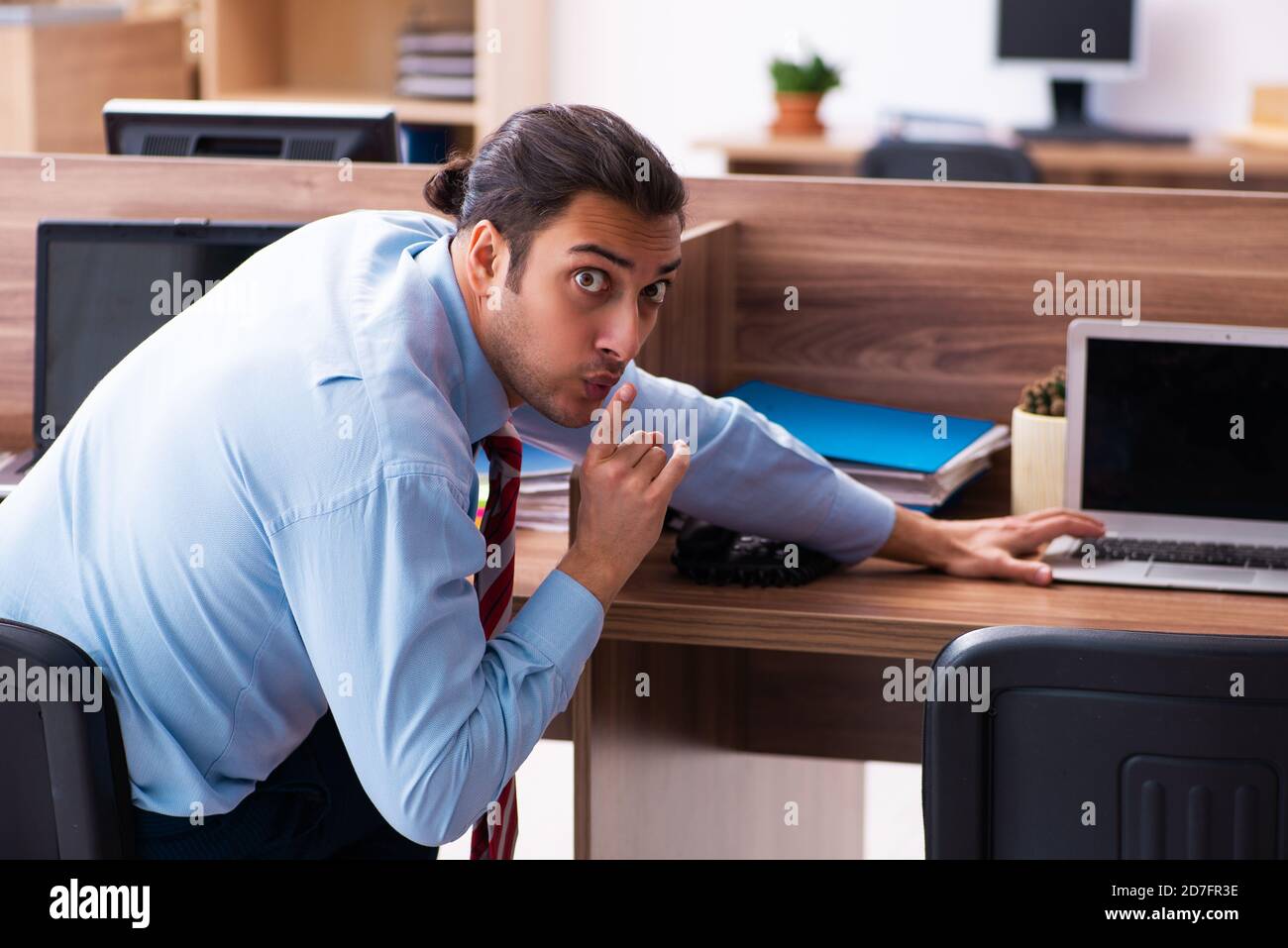 Male employee in industrial espionage concept Stock Photo - Alamy