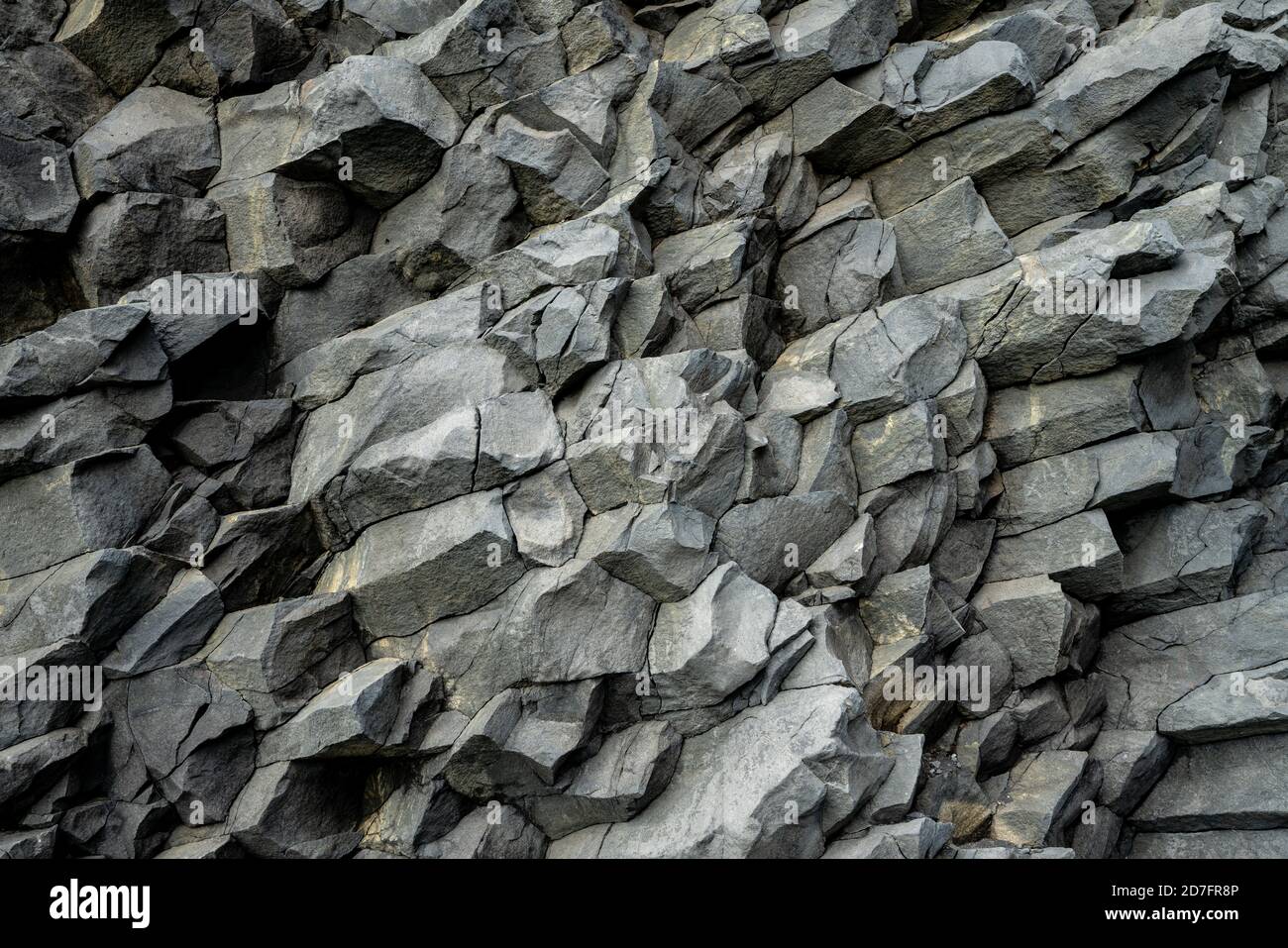 Backdrop from basalt volcanic rock formations in Reinisfjara beach near ...
