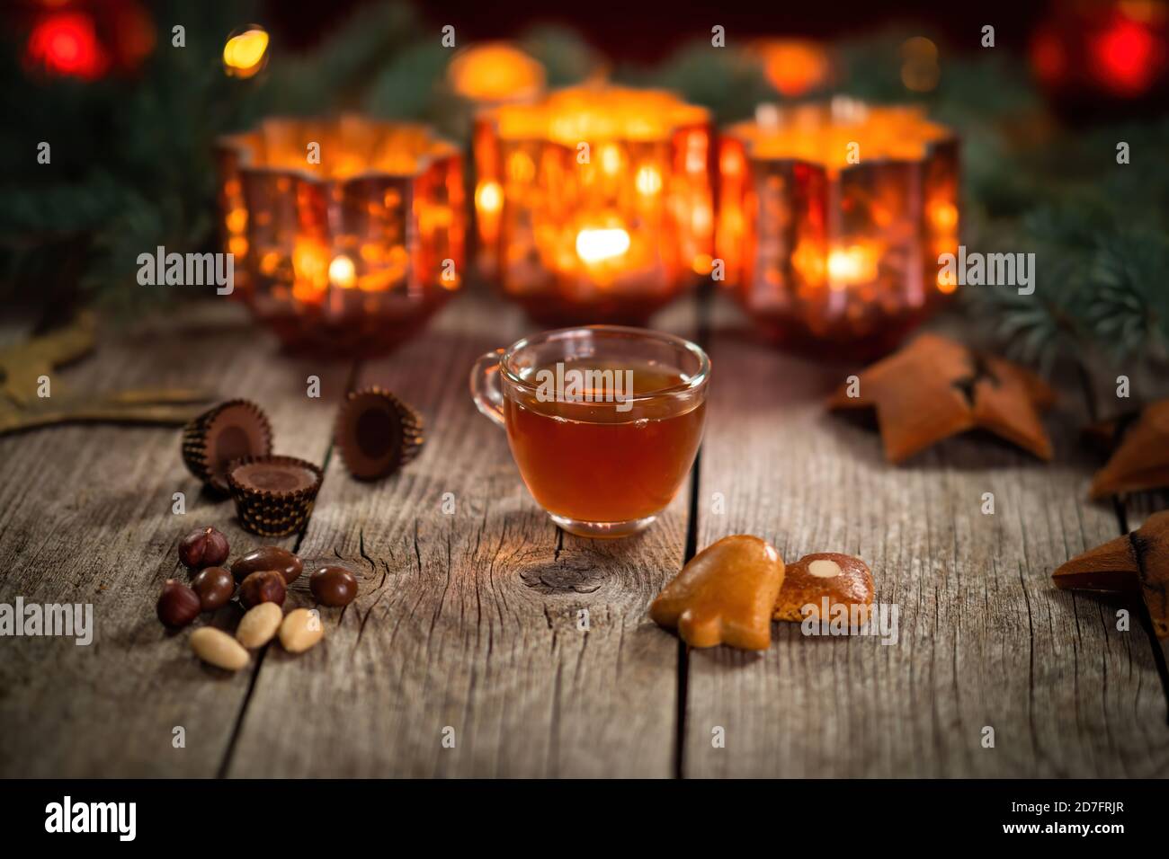 Homemade Christmas mulled wine punch with gingerbread, nuts and sweets on wooden rustic table ...