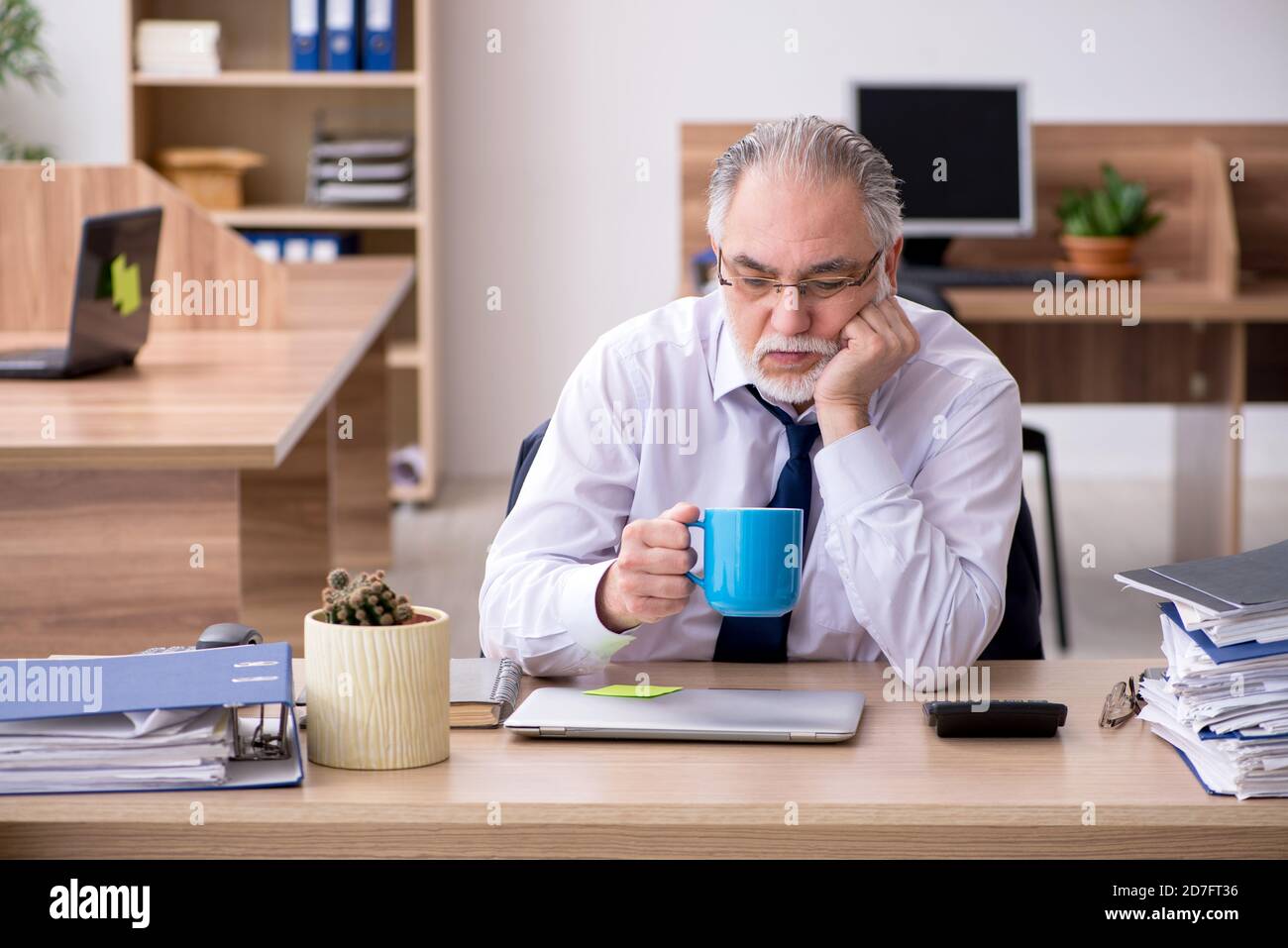 Old employee working in the office Stock Photo - Alamy
