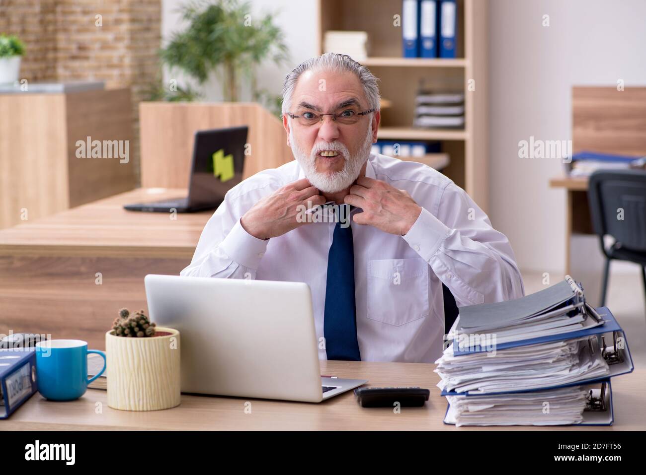 Old employee working in the office Stock Photo - Alamy