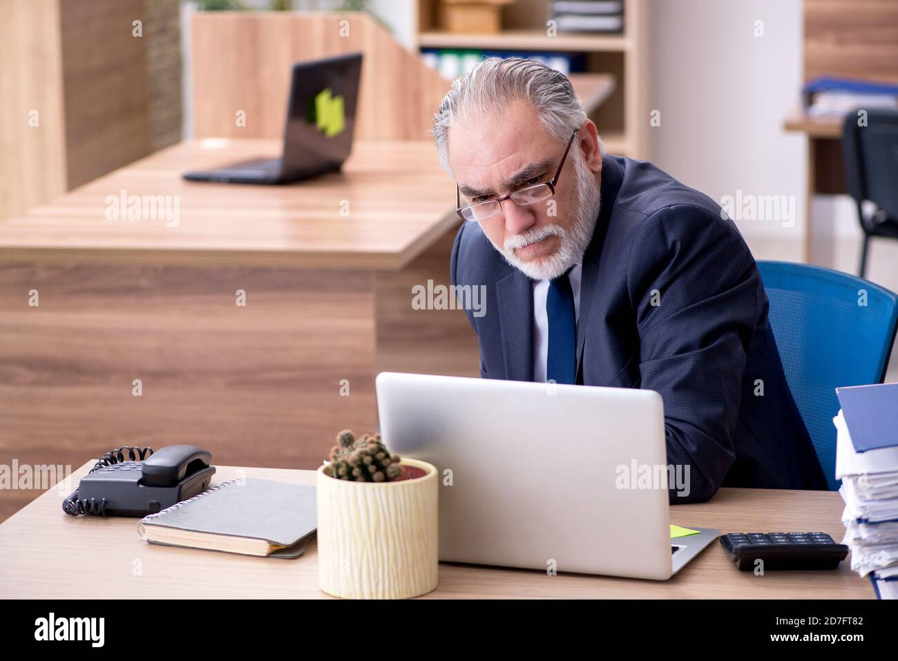 Old employee working in the office Stock Photo - Alamy